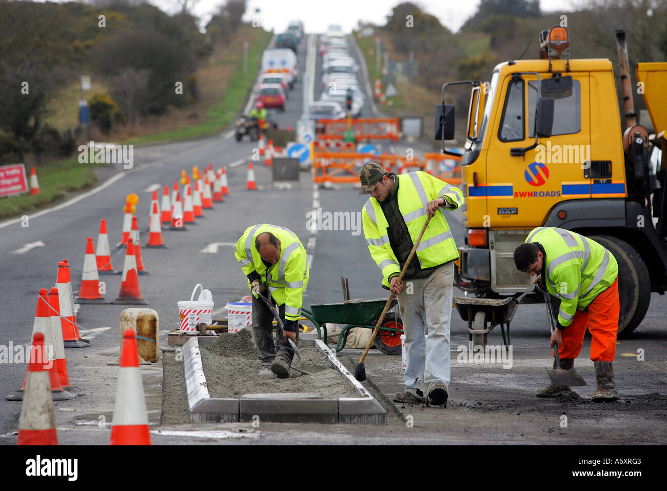road workers putting traffic islands into a main road Stock Photo - Alamy