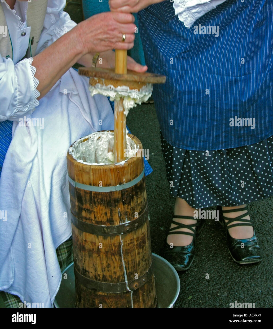 old tradition timber butter tub women by making butter Stock Photo - Alamy