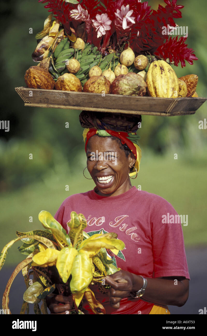 CARIBBEAN, Grenada, St. George, Smiling local Grenadian woman balancing ...