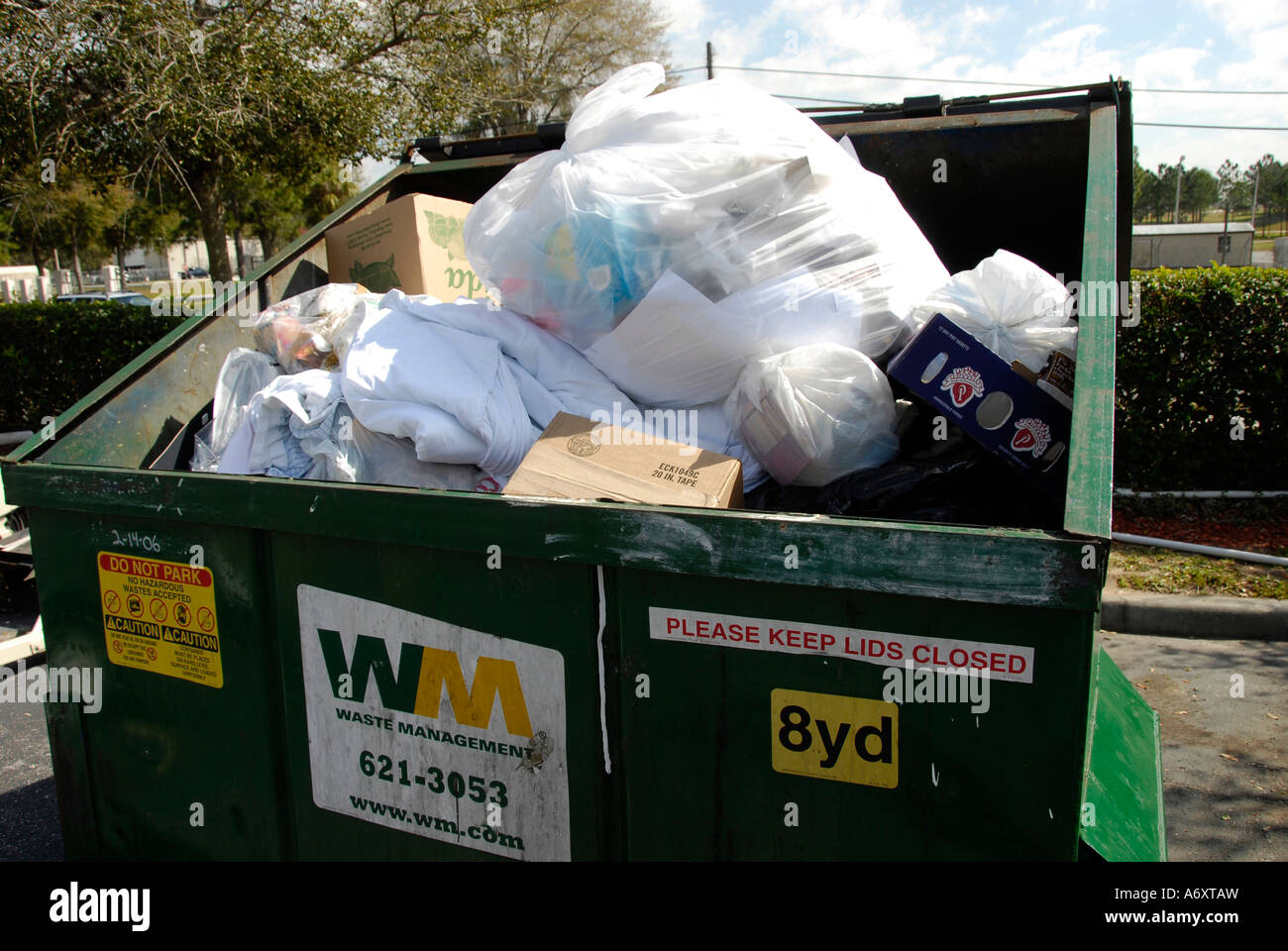 Trash container with household refuse Stock Photo - Alamy