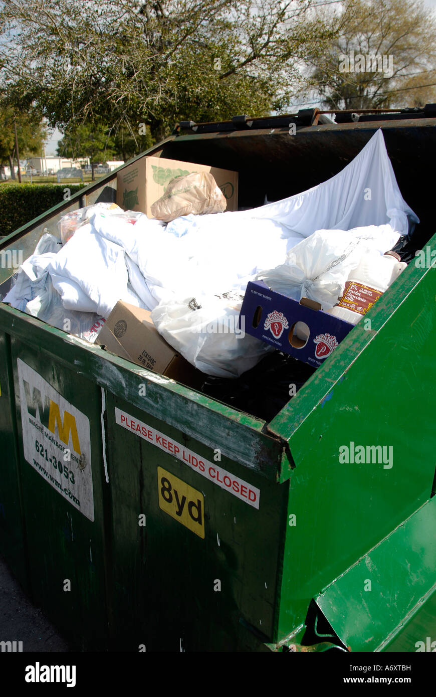 Trash container with household refuse Stock Photo - Alamy