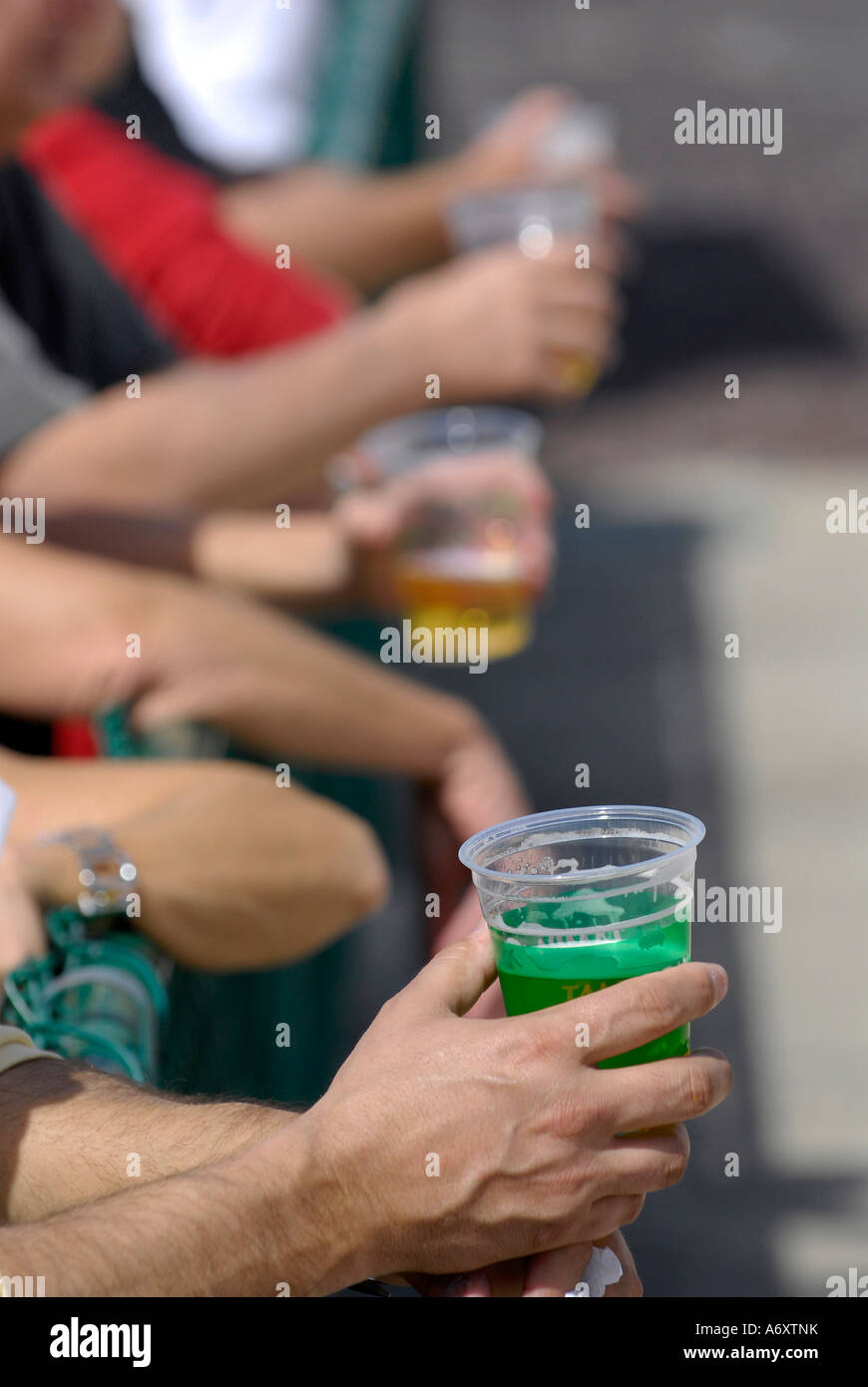 A cup of beer in hands of spectator at a sporting event Stock Photo - Alamy