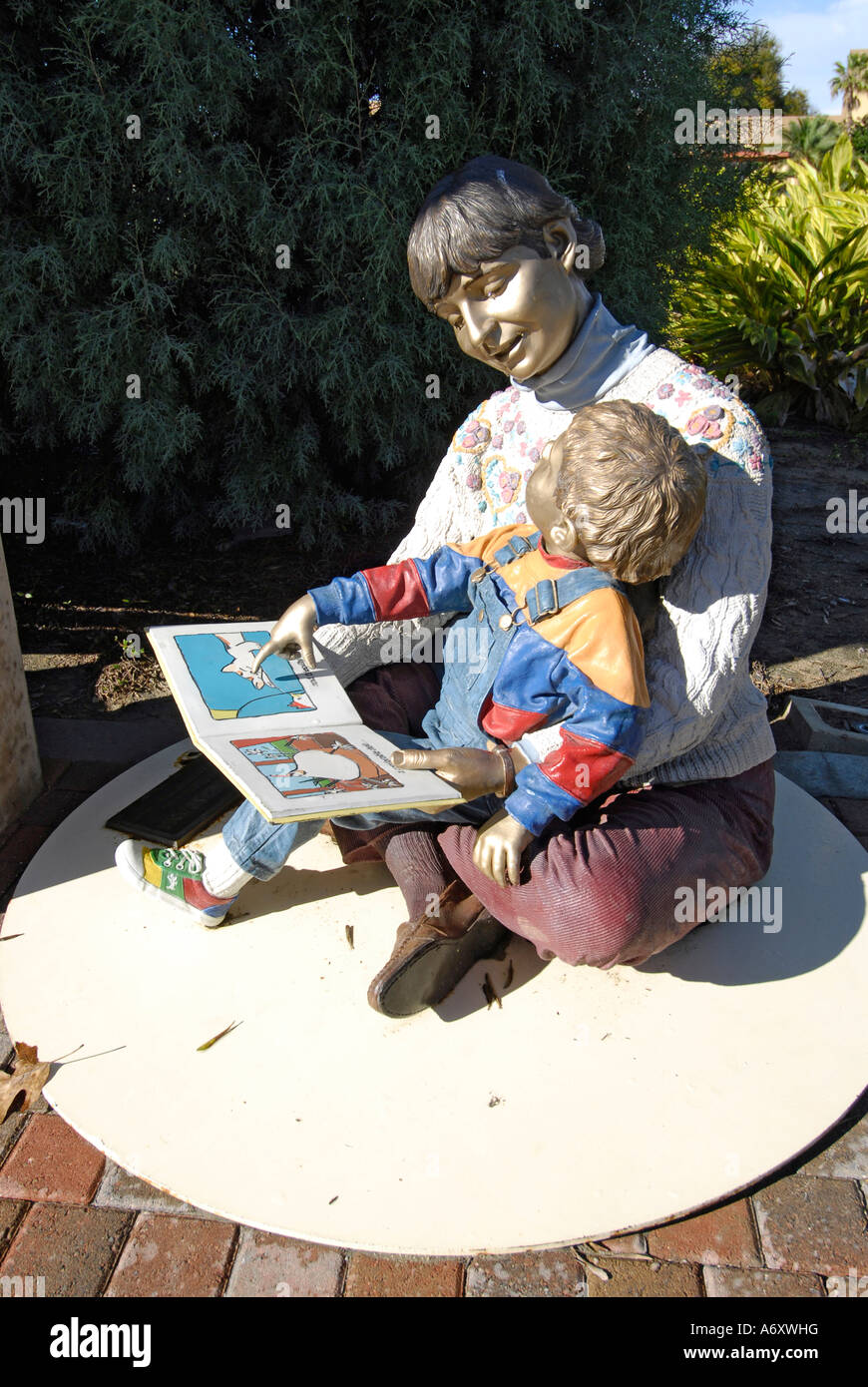 Statue of mother reading a book to her son in Barnett Family Park in ...