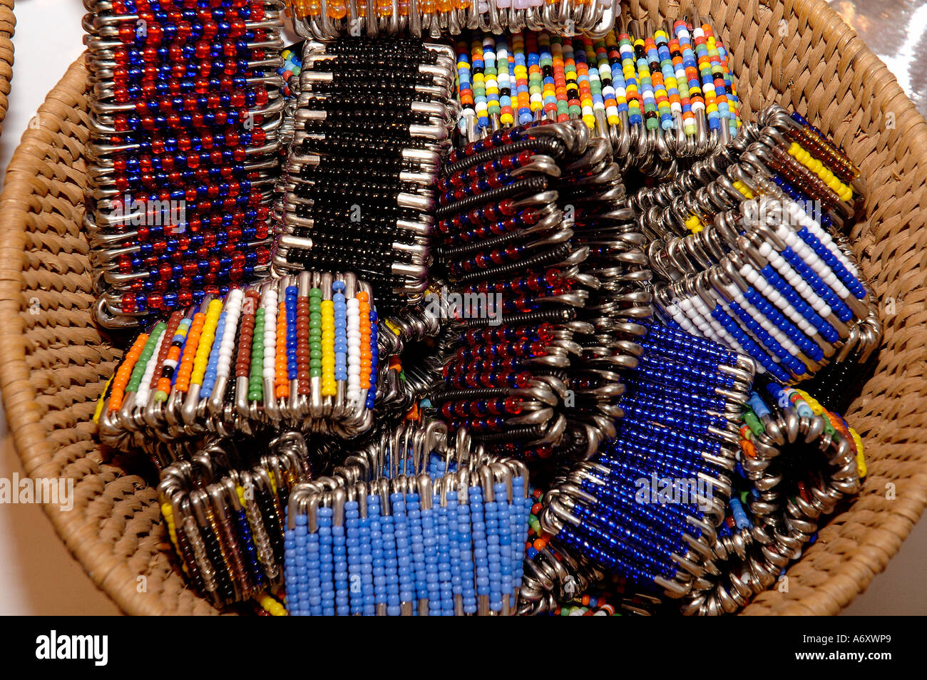 a collection of beaded bracelets made from safety pins for sale at a ...