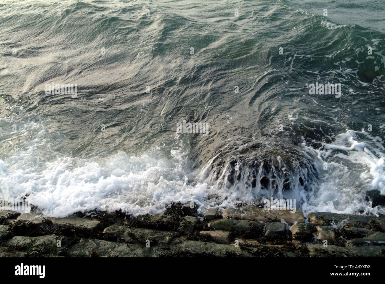 Shoreline with waves arriving on a breaker Stock Photo - Alamy