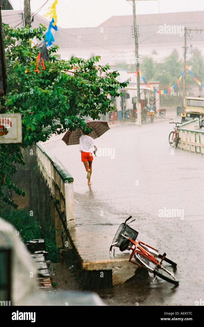 Boy running in rain storm Stock Photo - Alamy