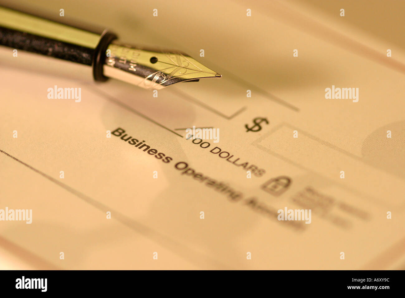 Fountain pen on business cheque Stock Photo - Alamy