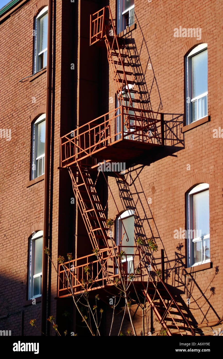 Fire escape on red brick building Stock Photo - Alamy