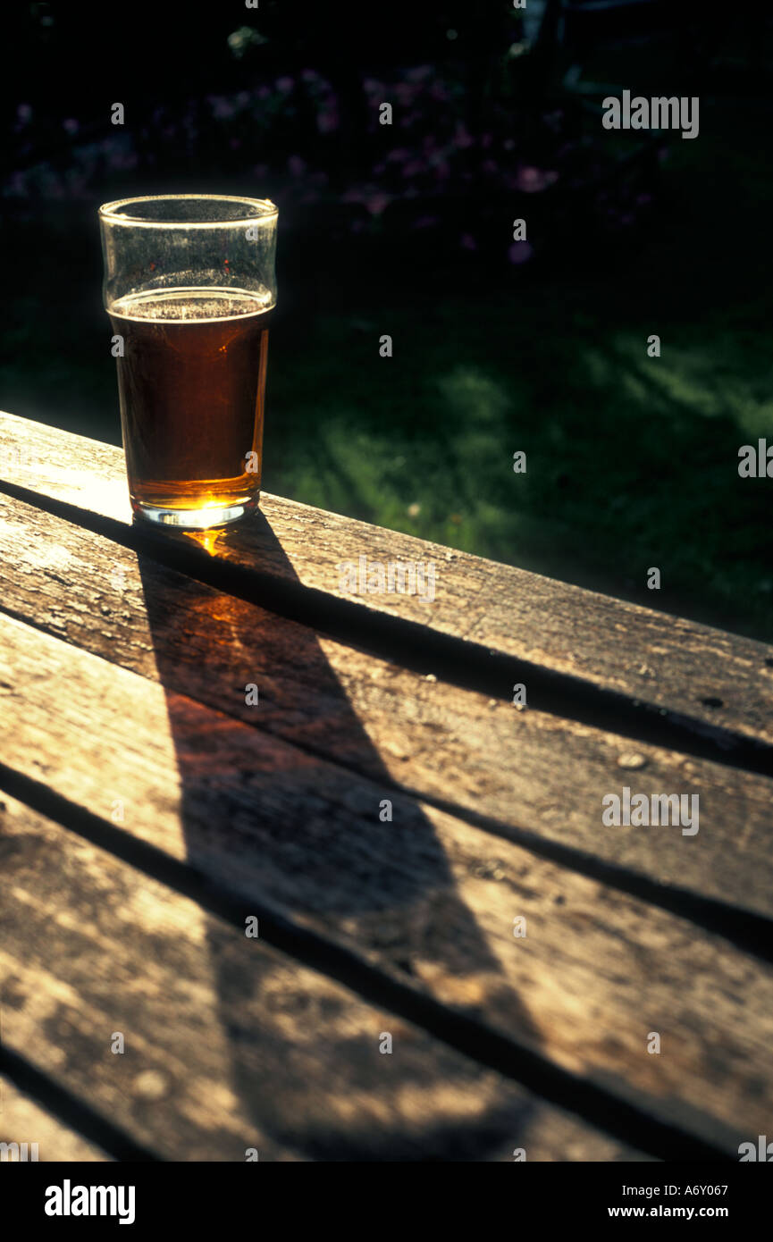 A pint of beer on a table in a beer garden of a British pub Stock Photo ...