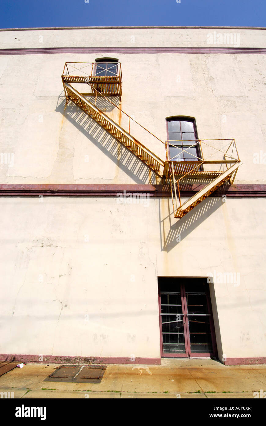 Fire escape lead from windows of a three story building to the ground ...