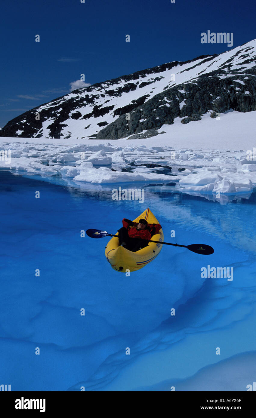 Woman Relaxing in Kayak Blue Melt Pond Juneau Icefield AK Stock Photo ...