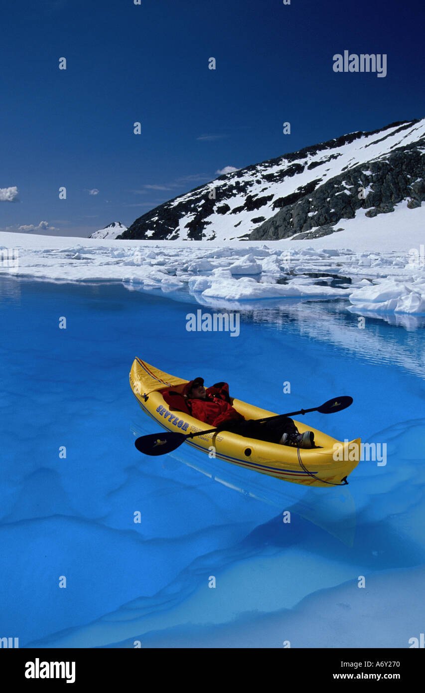 Woman Relaxing in Kayak Blue Melt Pond Juneau Icefield AK Stock Photo ...