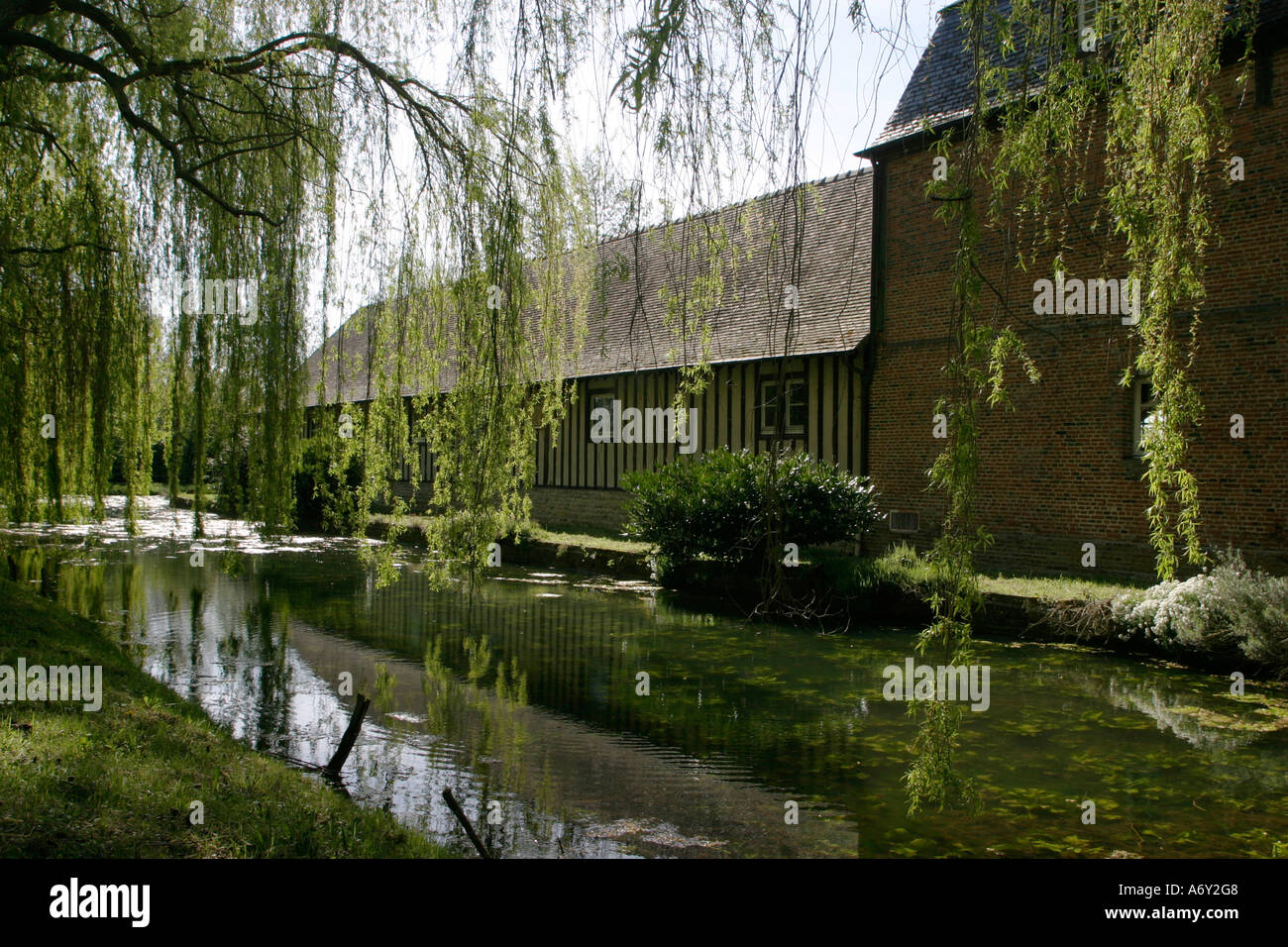 Trees overhanging a stream alongside the grounds to a chateau near ...