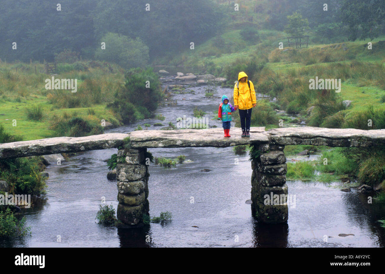 Stone clapper bridge Postbridge Dartmoor Devon England Rain River Stock ...