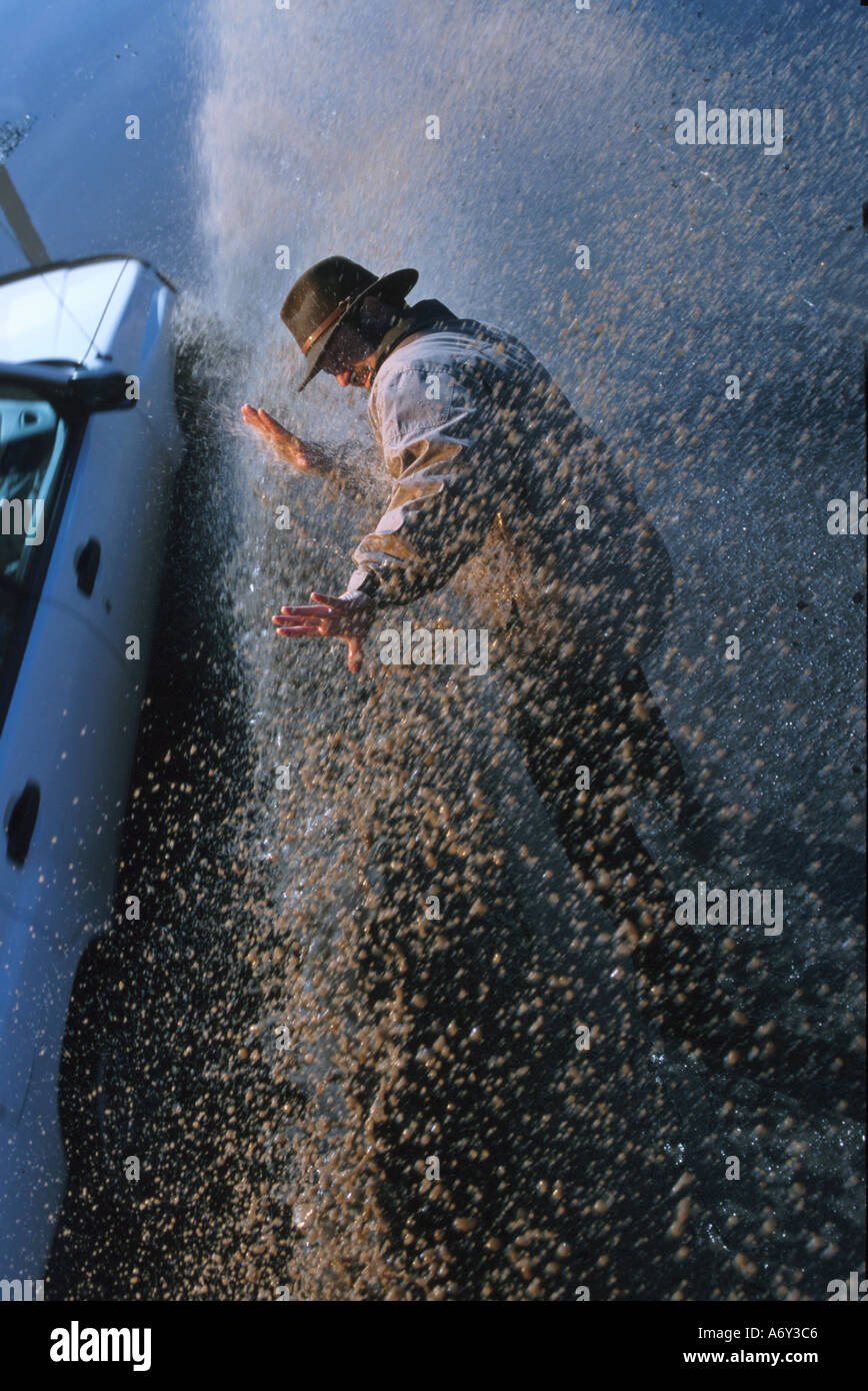 Car splashes man alongside road Southcentral Alaska spring portrait ...