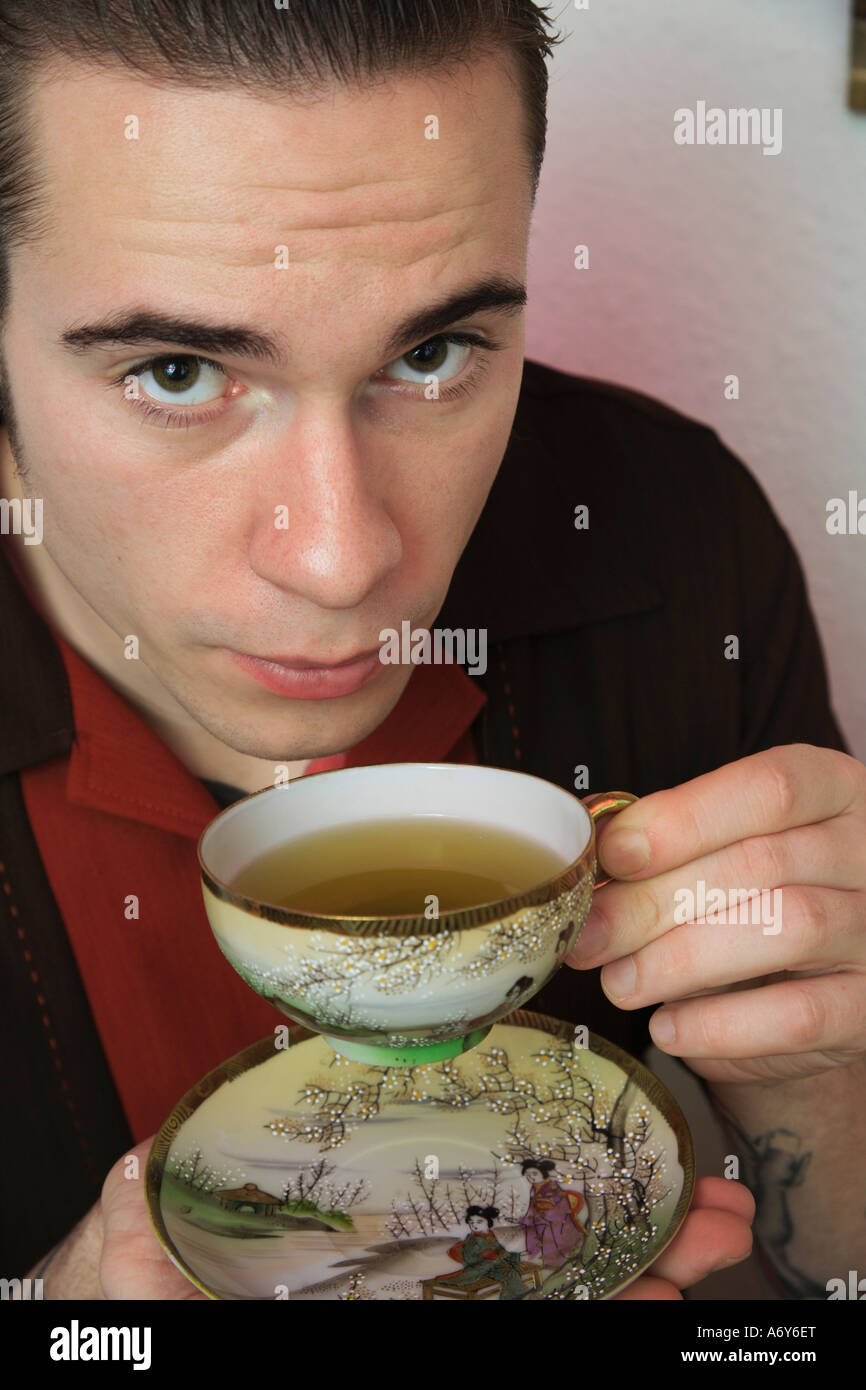 Young rockabilly man drinking tea Stock Photo - Alamy