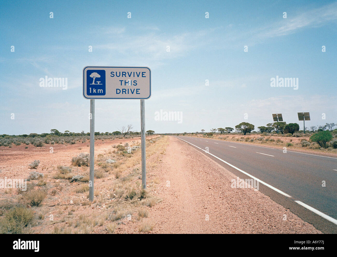 Road sign next to outback highway Stock Photo - Alamy
