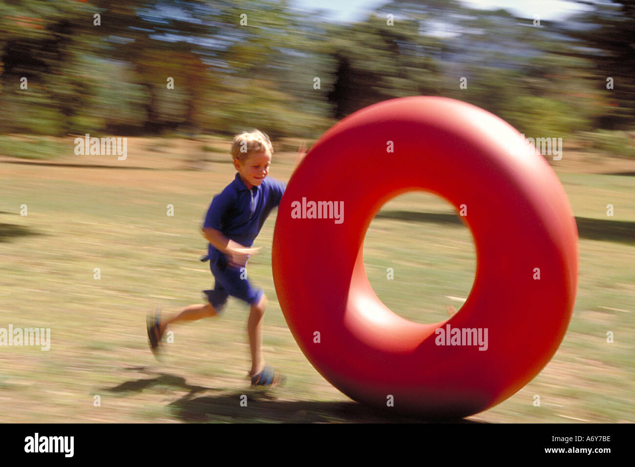 Boy rolling tire hi-res stock photography and images - Alamy