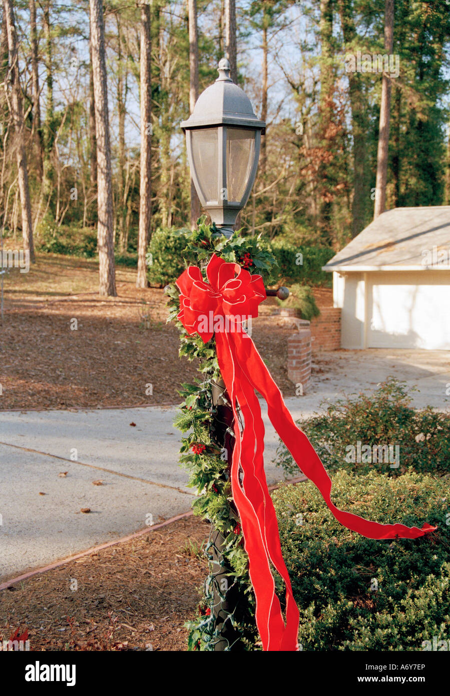 Lamppost decorated with Christmas lights ribbon and holly Stock Photo ...