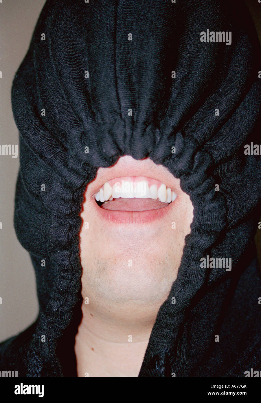 Man wearing a black hood over his face Stock Photo - Alamy