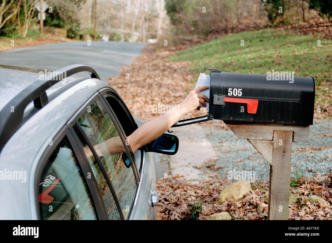 Person reaching for letters in a mailbox Stock Photo - Alamy