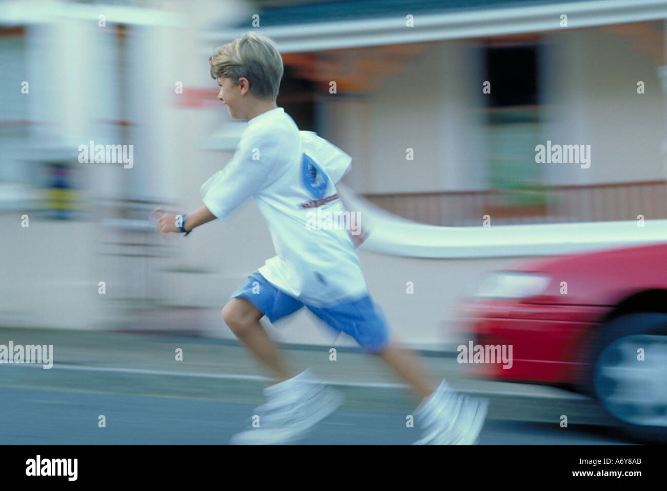 Boy fun running down street hi-res stock photography and images - Alamy