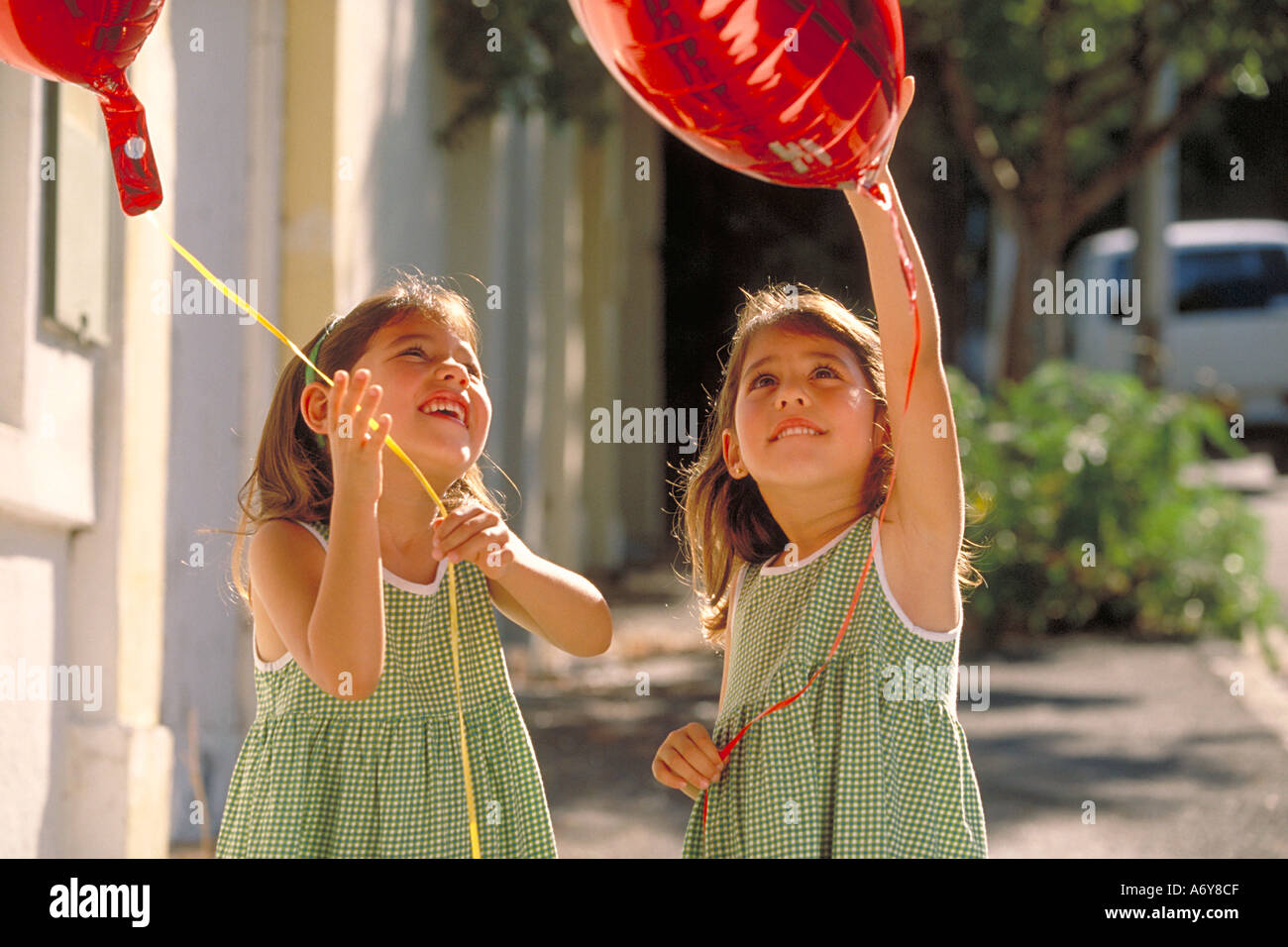 Happy twin sisters playing hi-res stock photography and images - Alamy
