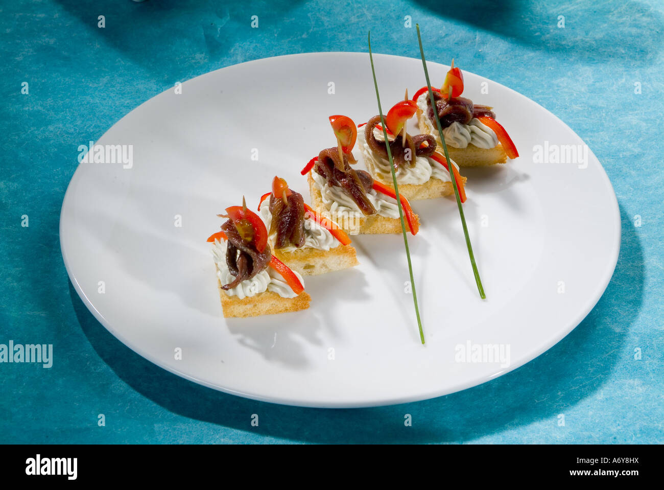 Tray of Philadelphia blue cheese triangles with anchovy and red pepper ...