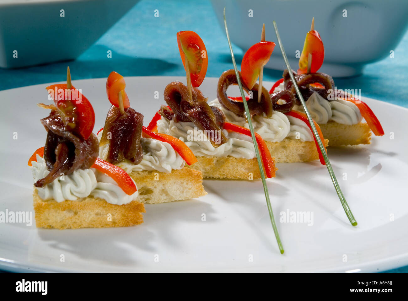 Tray of Philadelphia blue cheese triangles with anchovy and red pepper ...