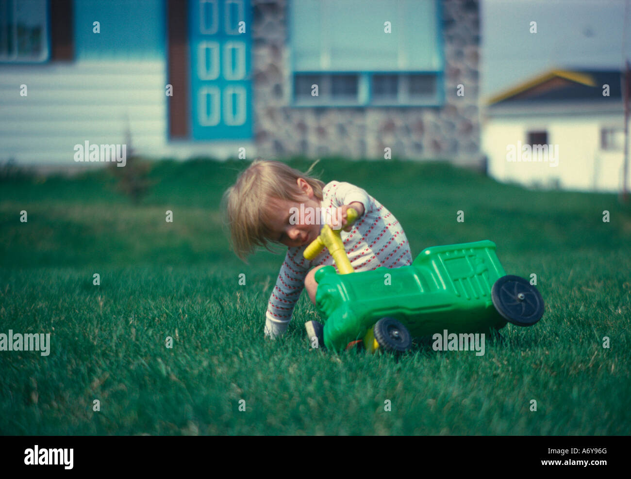 Young boy falling off a ride on plastic toy Stock Photo - Alamy