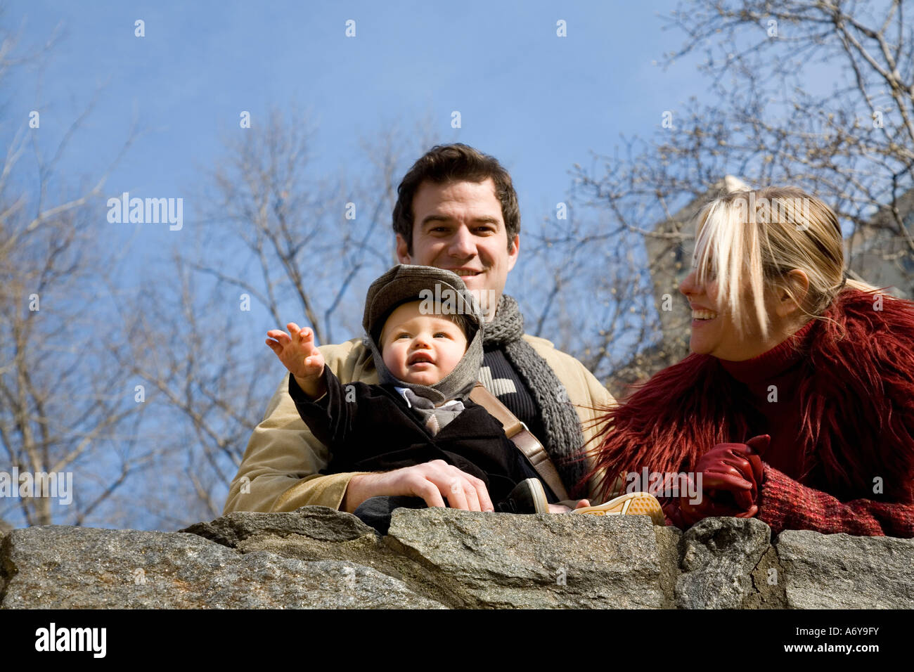 Family looking over a wall Stock Photo - Alamy