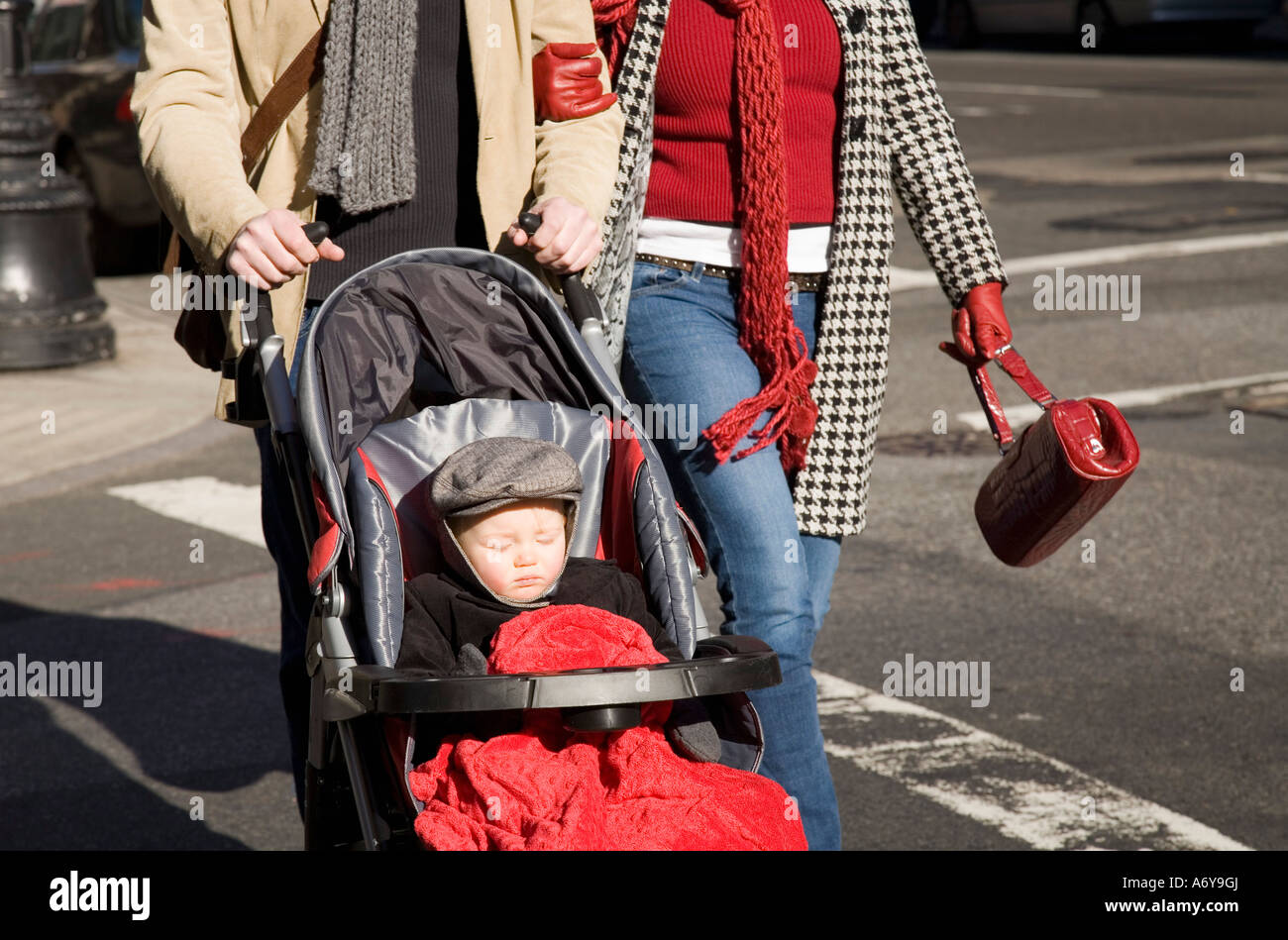 Midsection view of a couple pushing a pushchair Stock Photo - Alamy