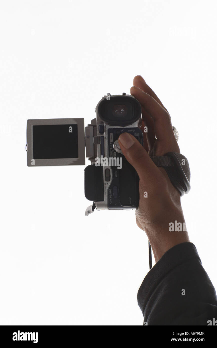 Hand holding a video camera Stock Photo - Alamy
