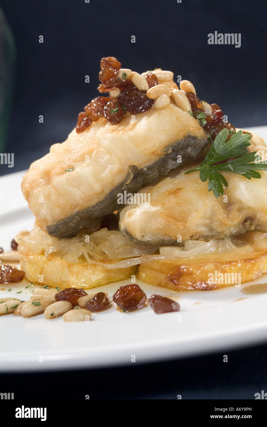 Cod with raisins and pine kernels Stock Photo - Alamy