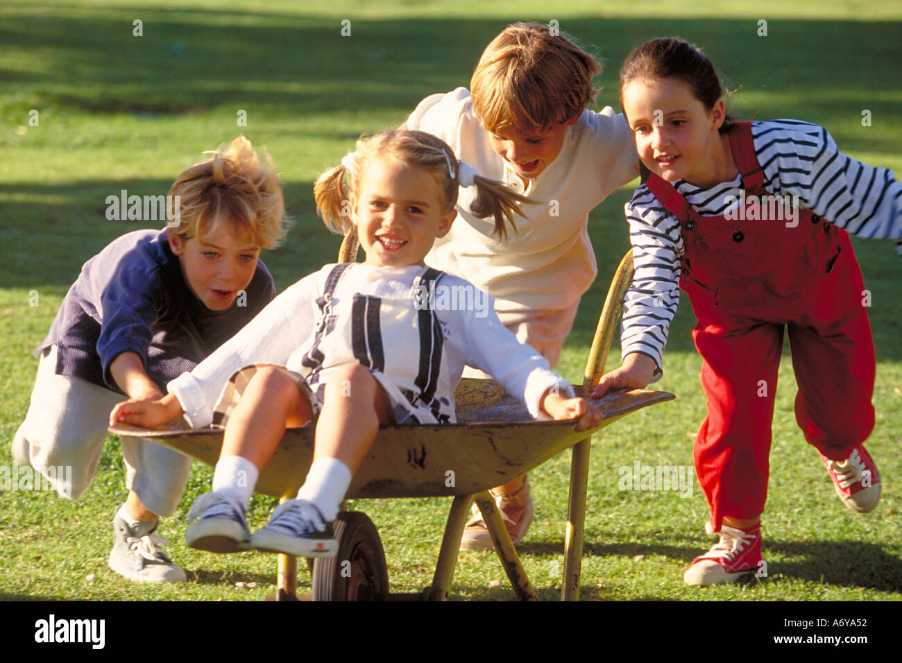 group of kids pushing wheel barrow Stock Photo - Alamy