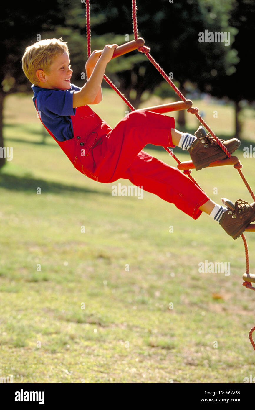 boy climbing steps of ladder Stock Photo - Alamy