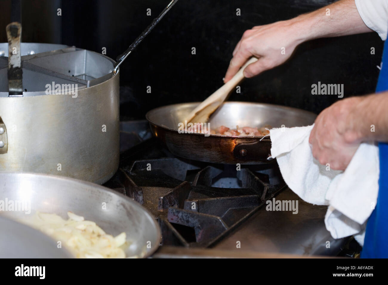 Chef stirring pots of food cooking on a stove Stock Photo - Alamy