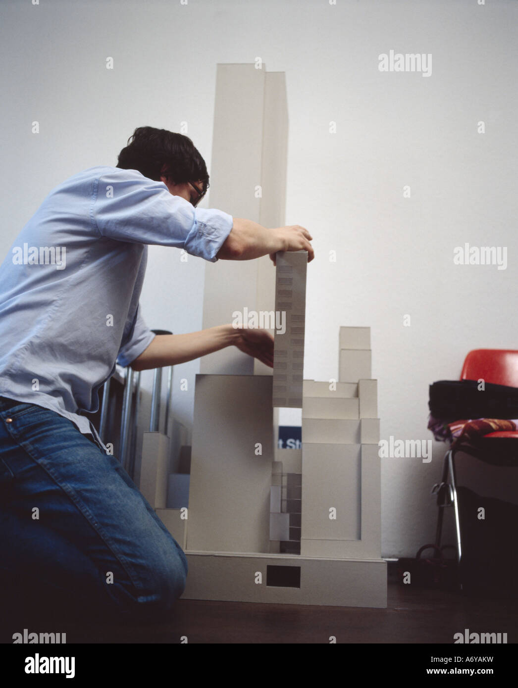 Young man building an architectural model Stock Photo - Alamy