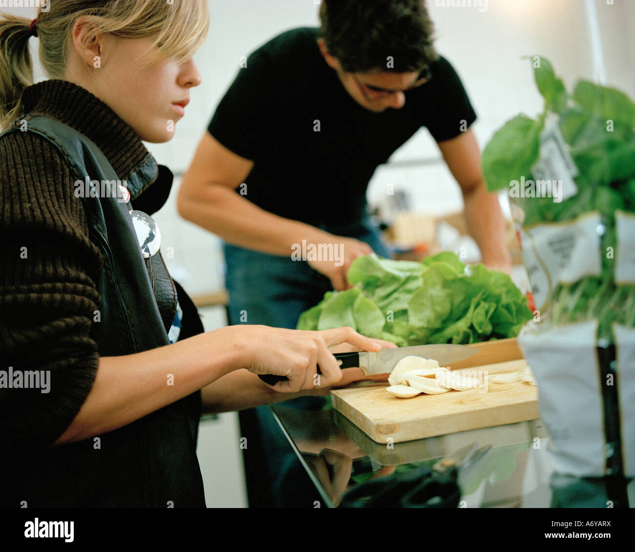 Young man preparing food woman hi-res stock photography and images - Alamy