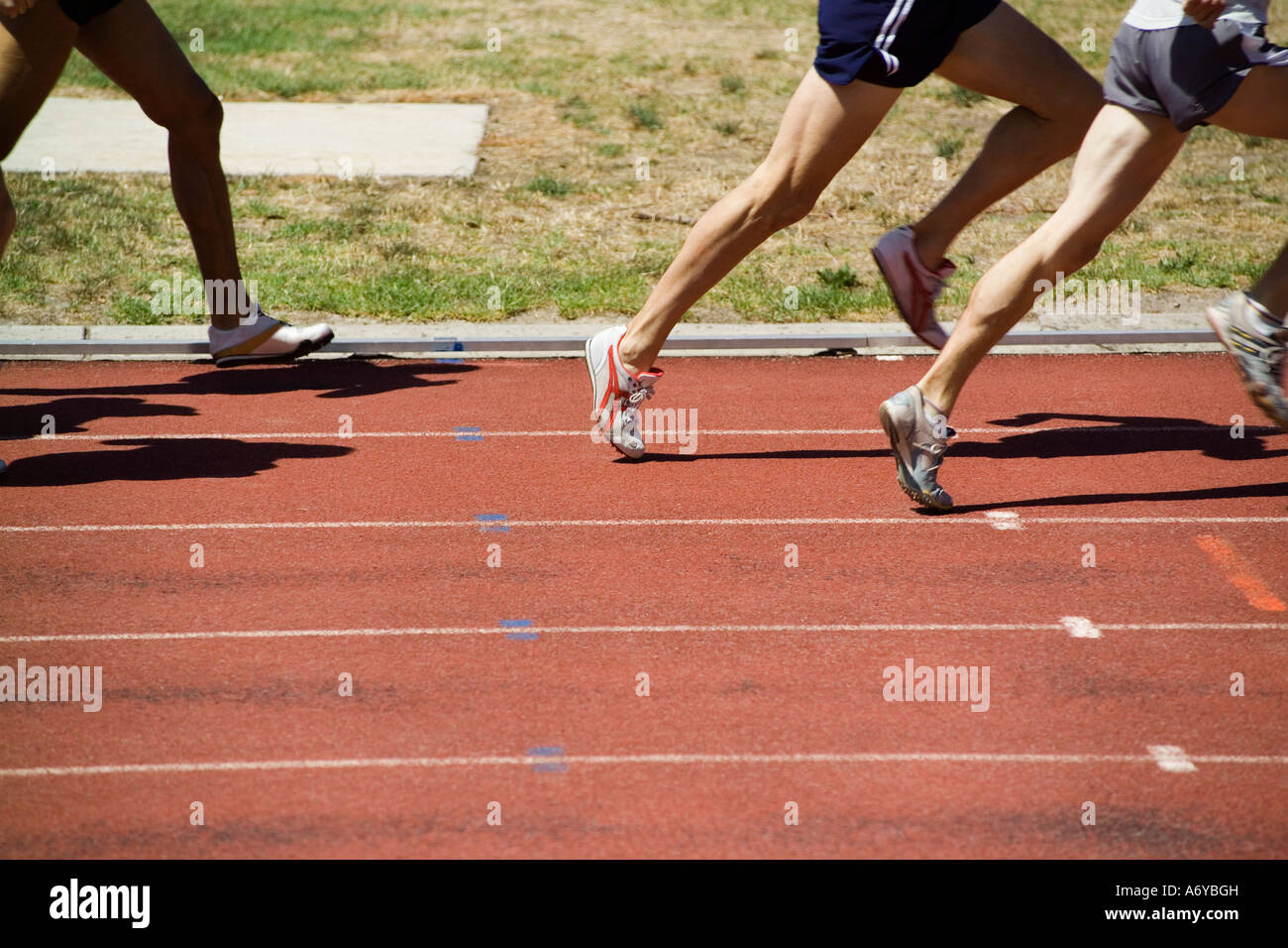 Group of male athletes running on a track Stock Photo - Alamy