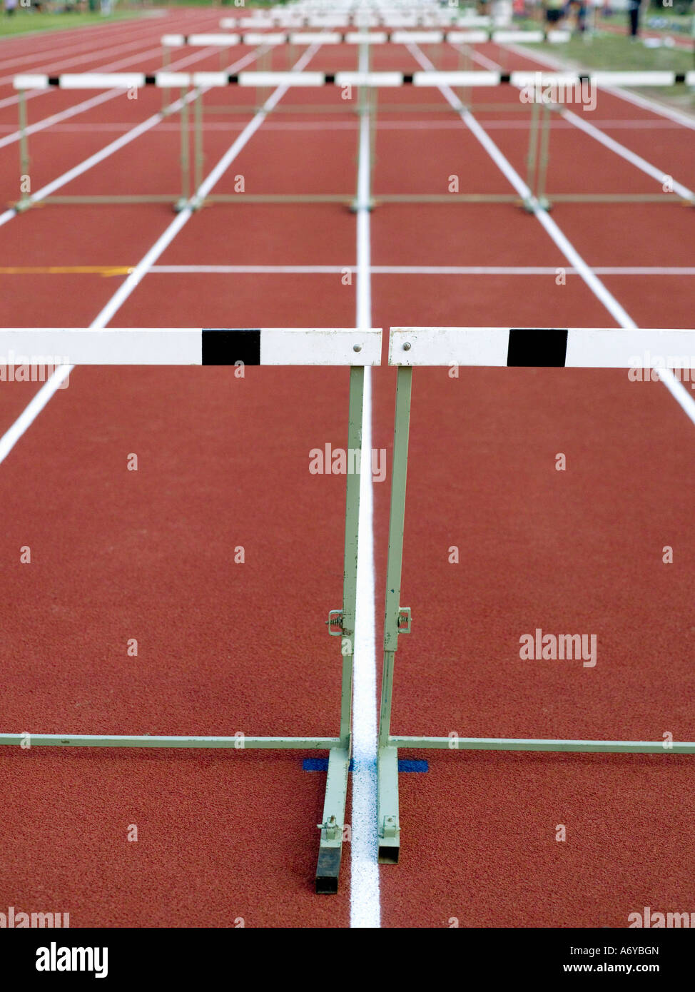 Hurdles arranged on a running track Stock Photo - Alamy