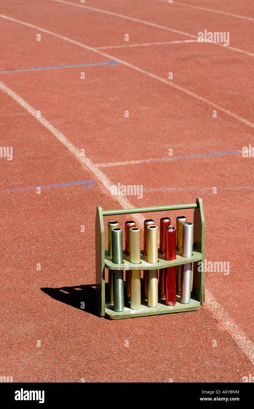 Crate of relay batons on a running track Stock Photo - Alamy
