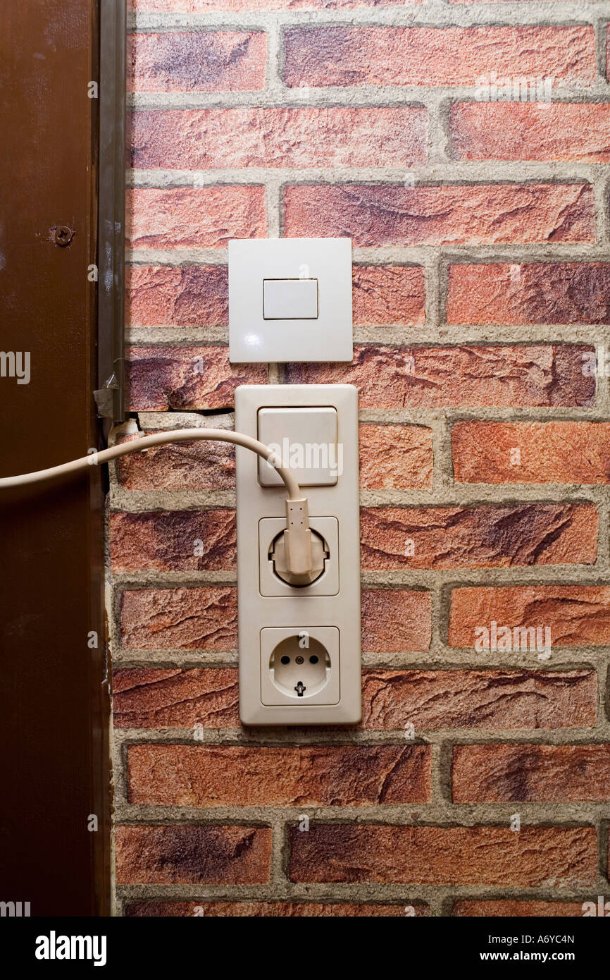 Electric plug and socket on a wall Stock Photo - Alamy