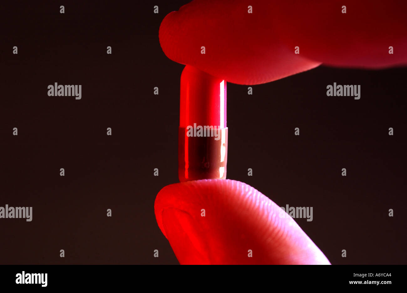 Horizontal color image of a person holding a pill or capsule Stock ...
