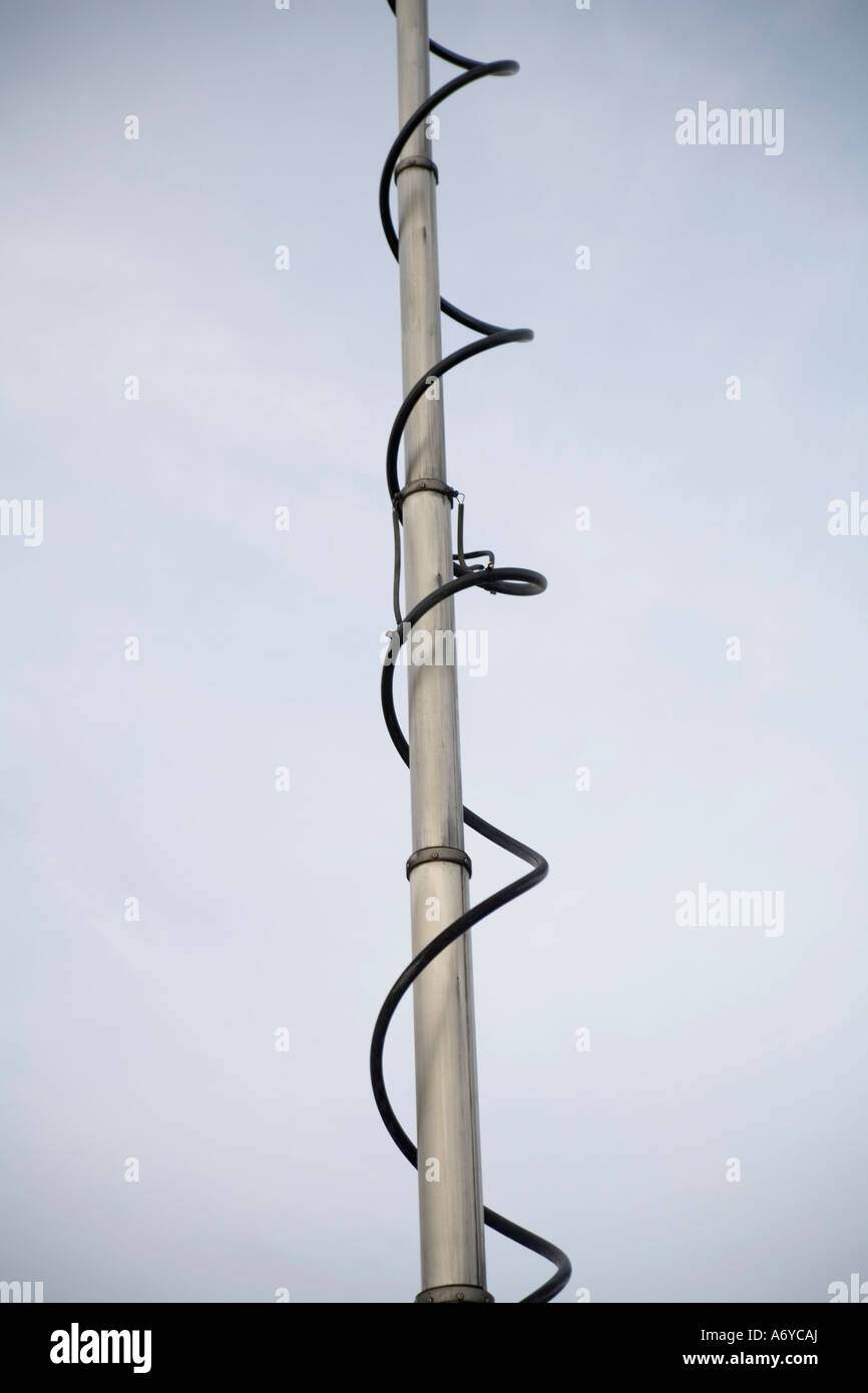 Metal post with cable spiraling around Stock Photo - Alamy