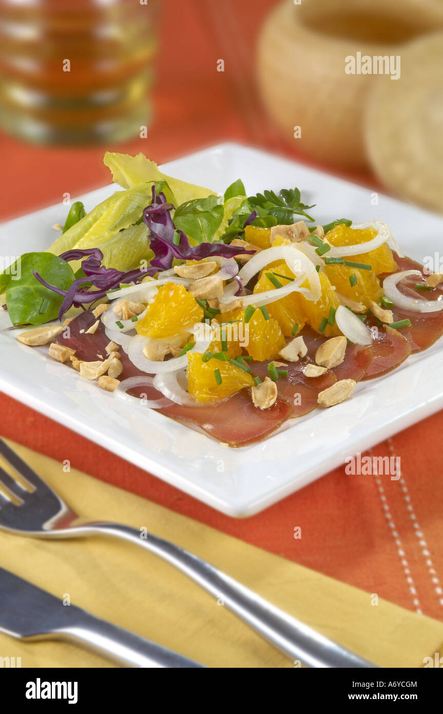 Dried salted tuna with orange spring onion and almonds Stock Photo - Alamy