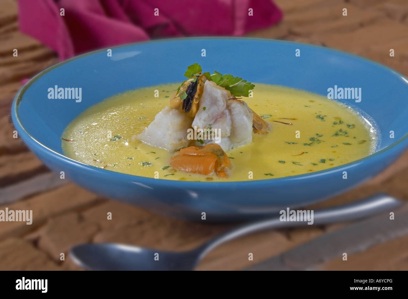 Mussel and monkfish soup with saffron Stock Photo - Alamy