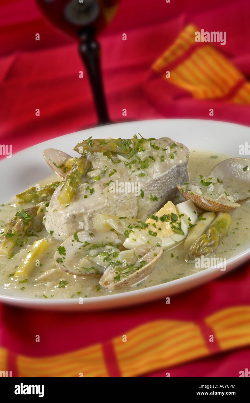 Koskera Basquian style hake with green asparagus Stock Photo - Alamy