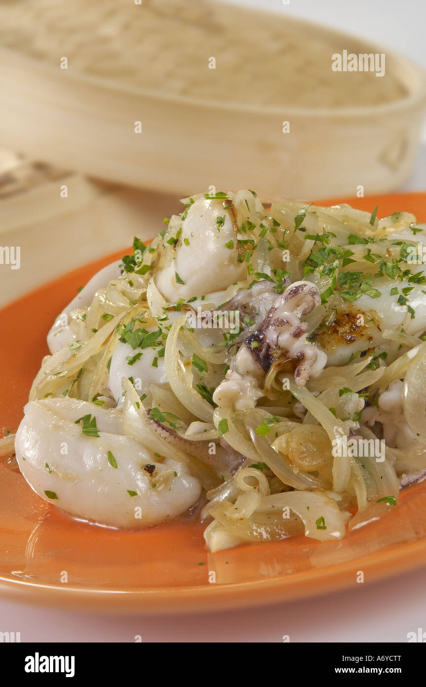 Baby squid cooked with onions Stock Photo - Alamy