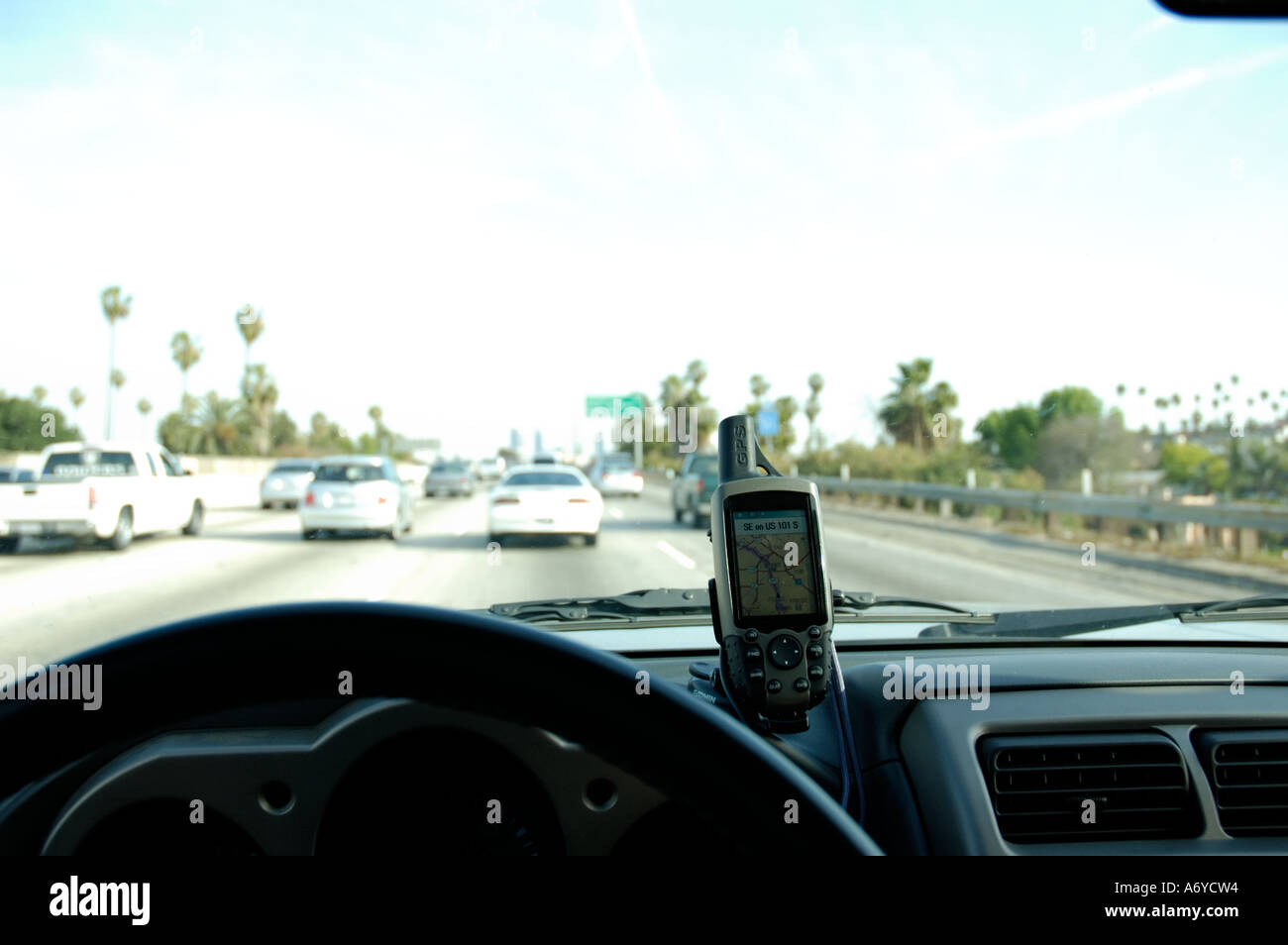 GPS unit mounted on vehicle's dashboard. Driving on freeway Stock Photo ...